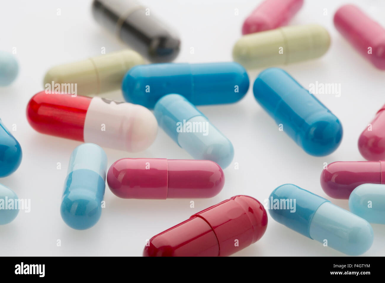 Various colorful medicine capsules on white background Stock Photo - Alamy