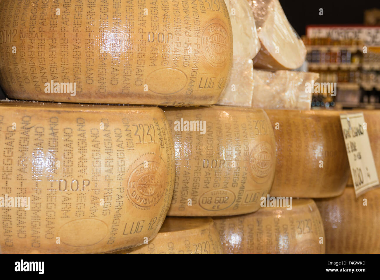 stacked circular blocks of Parmigiano Reggiano Italian cheese for sale ...