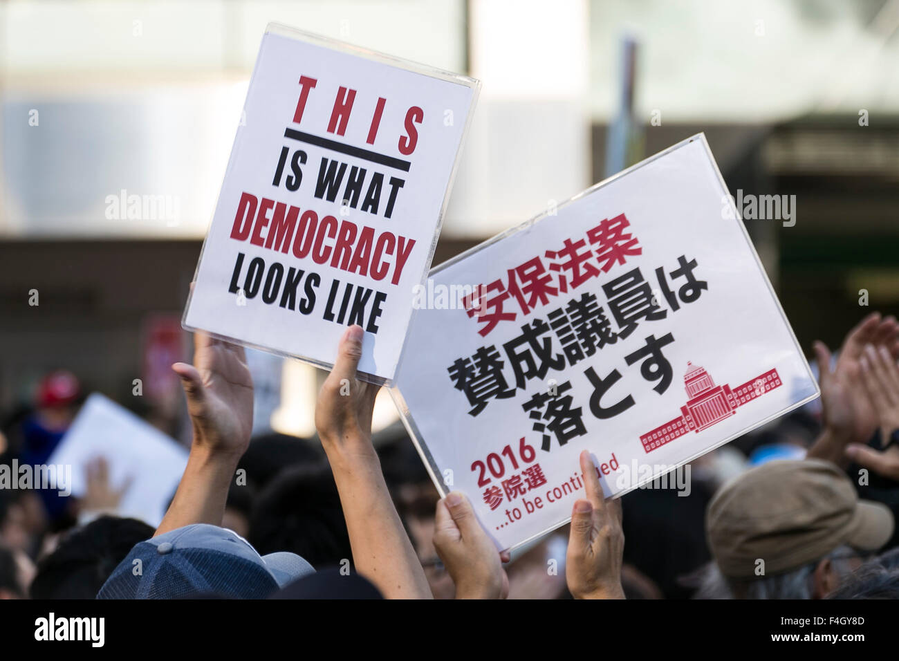 Demonstrators hold placards calling for democracy during a protest ...