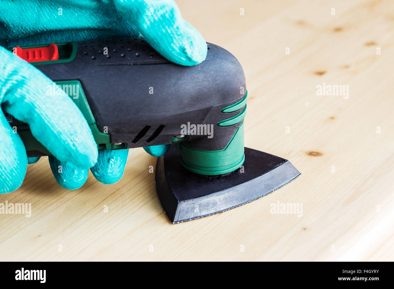 Worker using electric grinder machine Stock Photo - Alamy