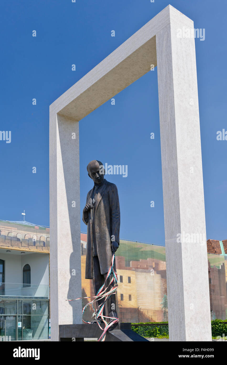 A sculpture of an old man standing within a concrete white frame ...