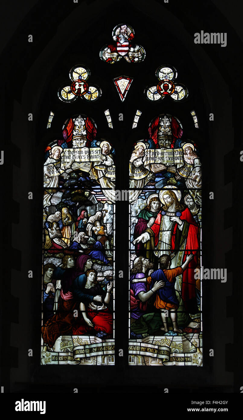 A stained glass window depicting Jesus casting out the demons and ...