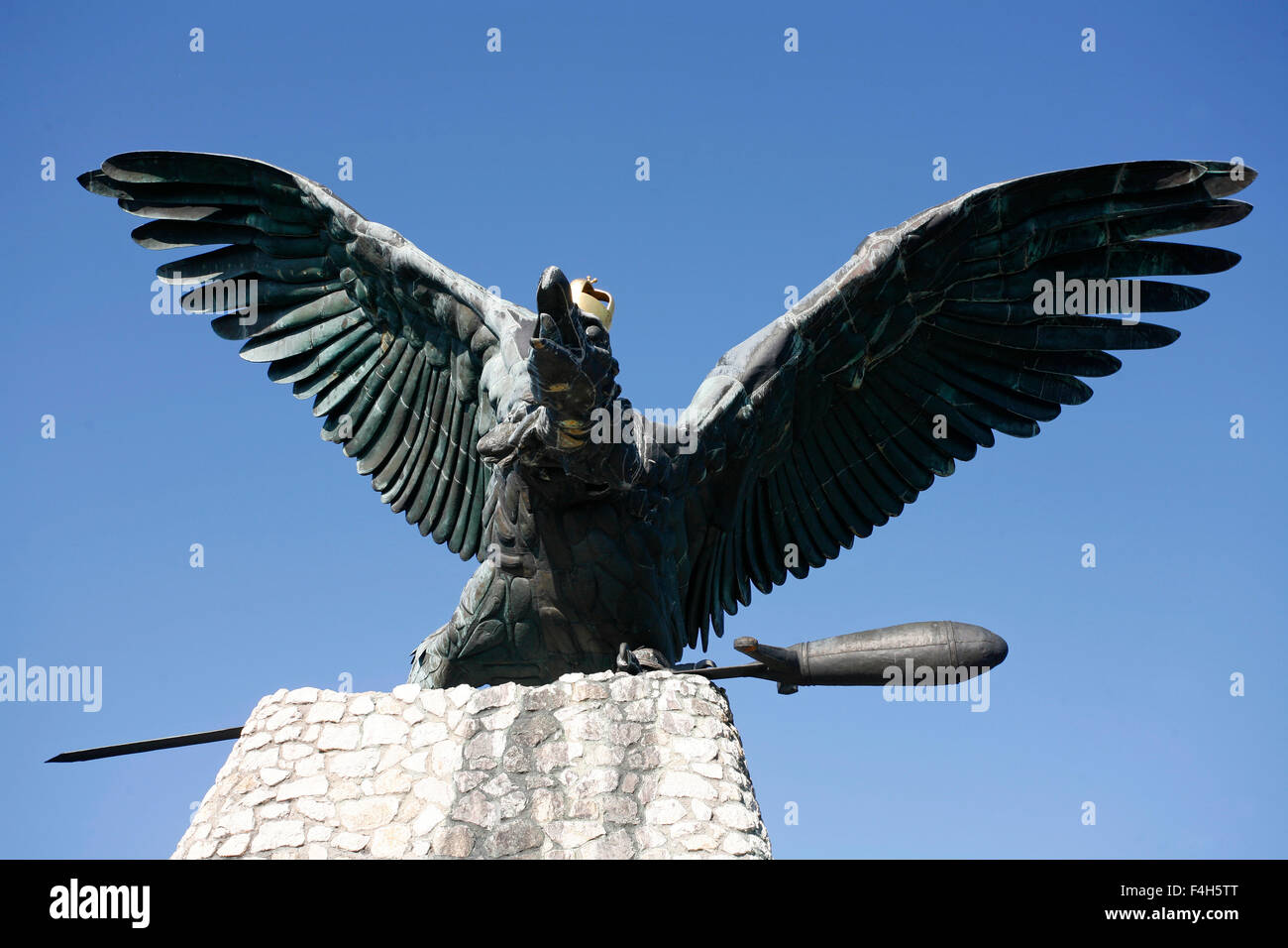 Statue of the famous hungarian legendary Turul bird against blue sky ...