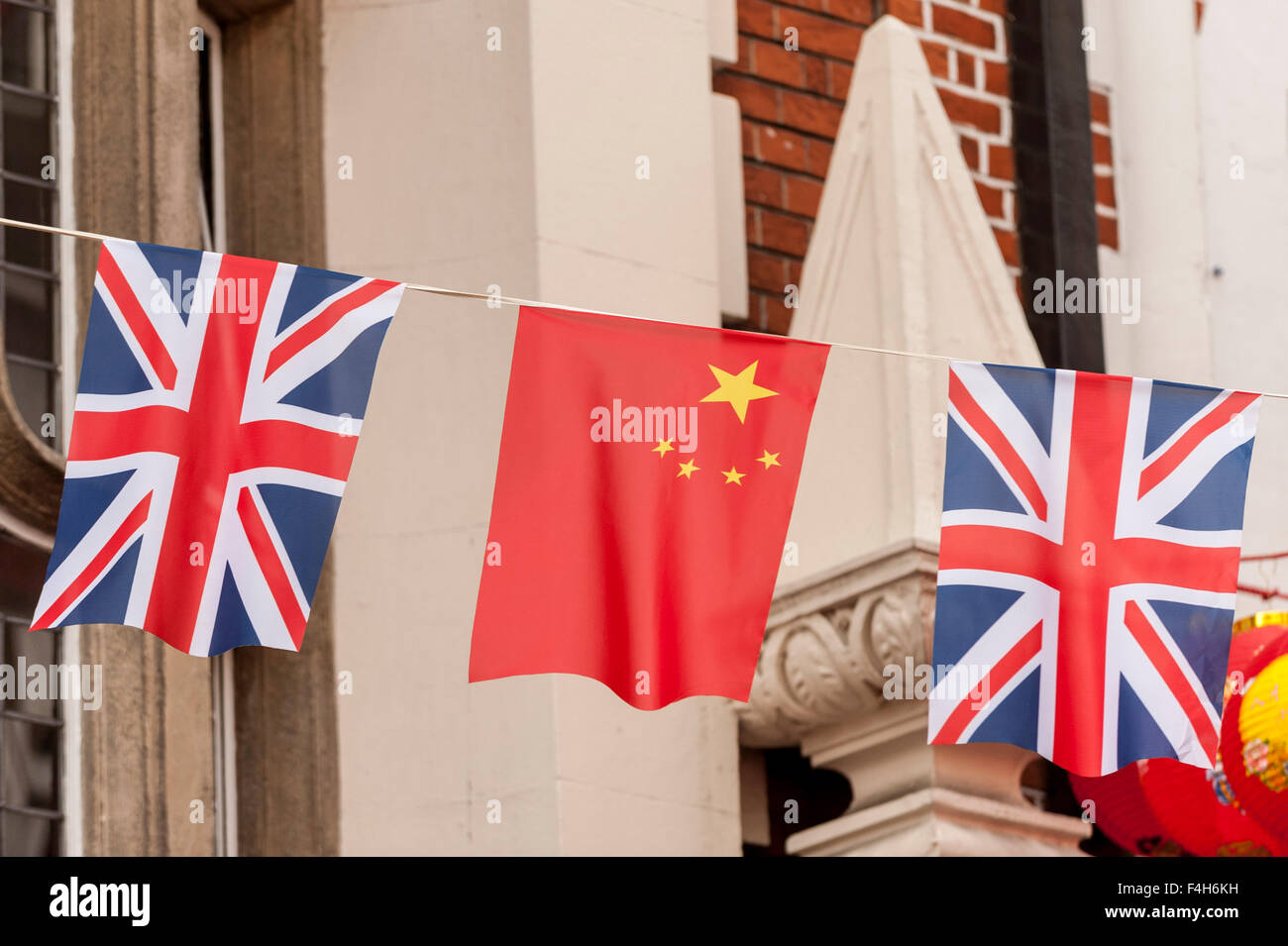 London, UK. 18 October 2015. Chinese flags and Union Jack flags hang ...