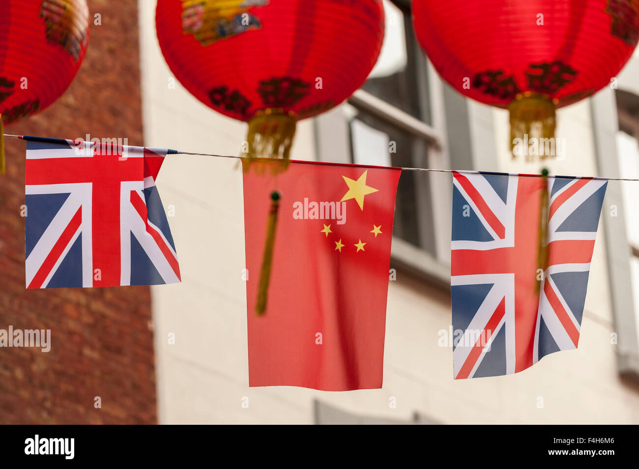 London, UK. 18 October 2015. Chinese flags and Union Jack flags hang ...
