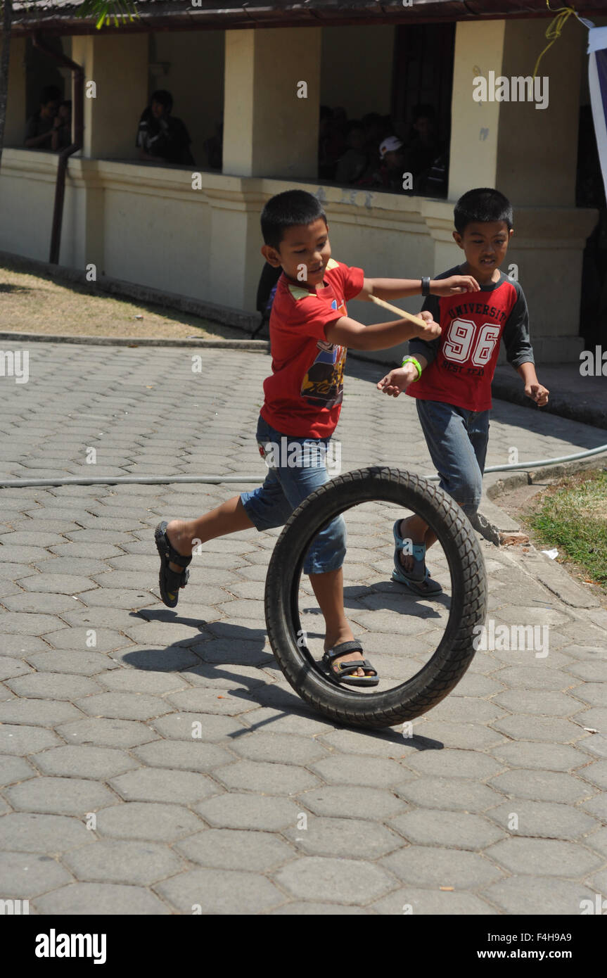 Boy rolling tire hi-res stock photography and images - Alamy