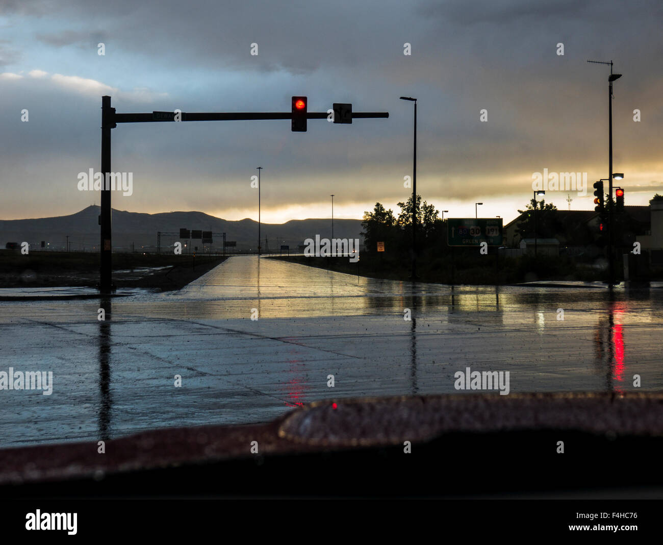 Windshield view of rain storm; traffic light; road intersection; Rock ...