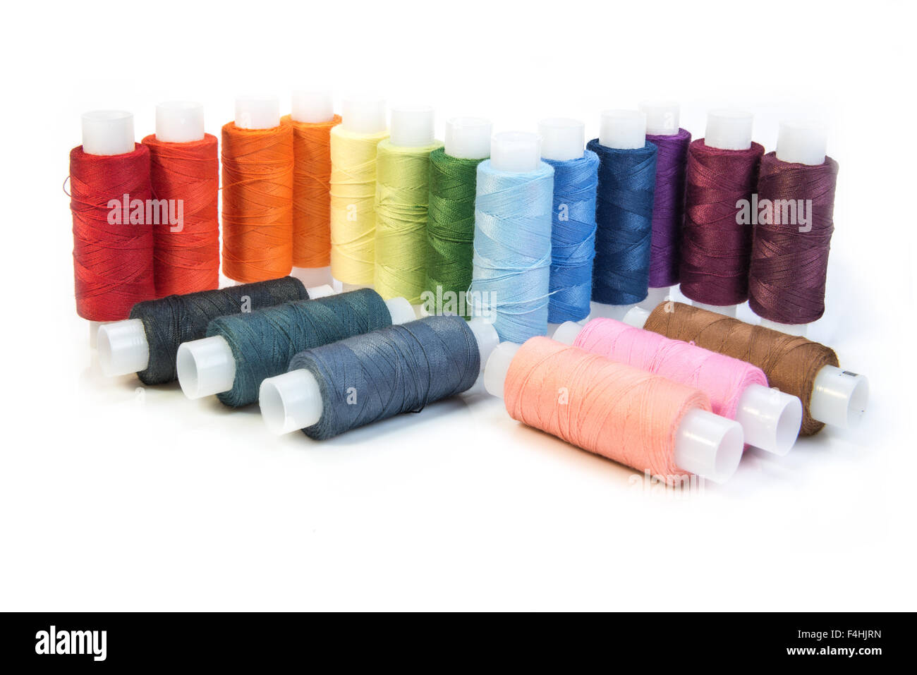 multicolored threads for sewing on spools isolated on white background ...
