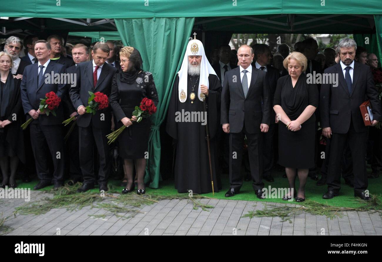 Russian President Vladimir Putin standing with widow Irina Primakov her ...