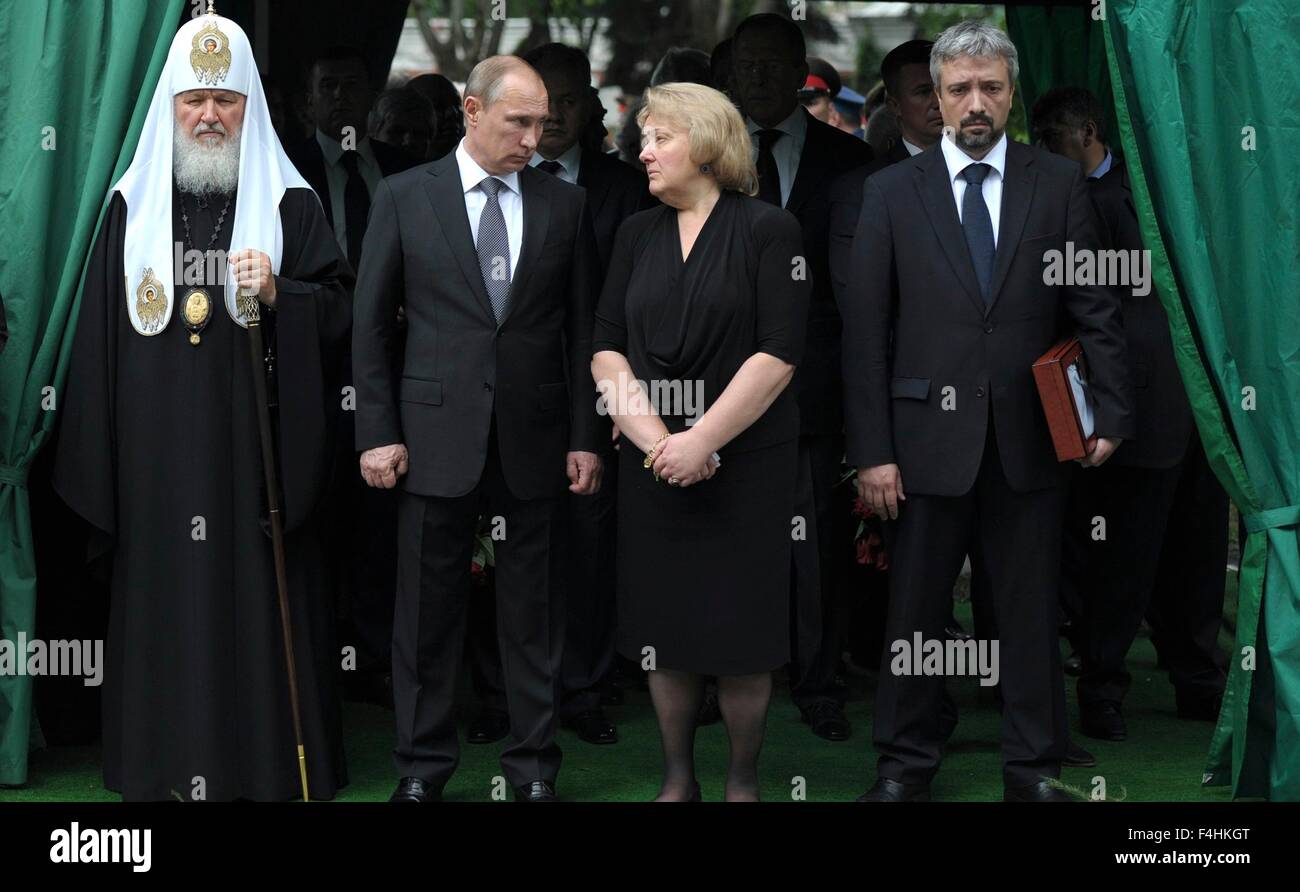 Russian President Vladimir Putin standing with widow Irina Primakov her ...