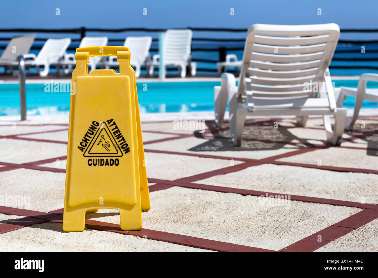 Wet floor warning sign near a swimming pool Stock Photo - Alamy