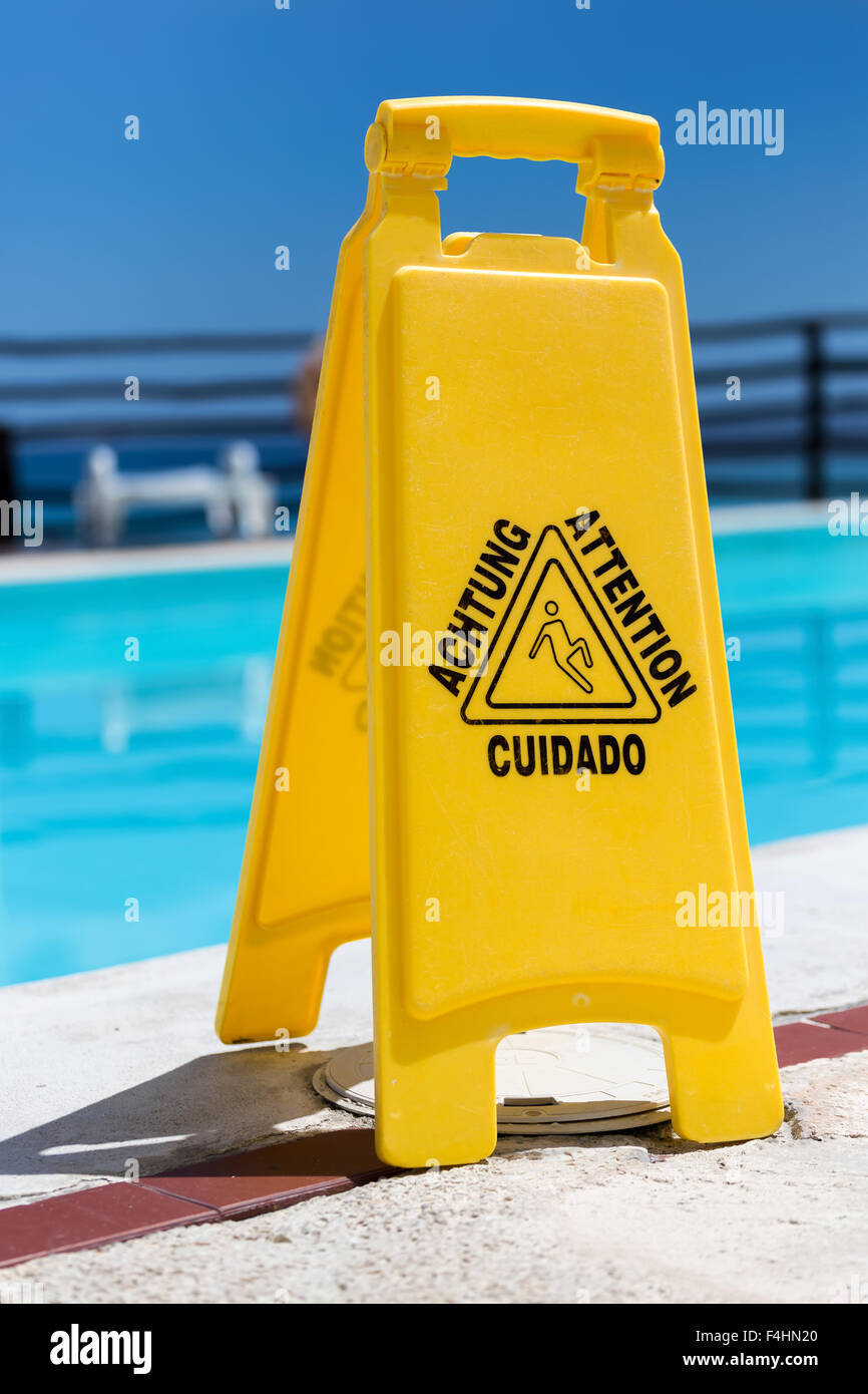 Wet floor warning sign near a swimming pool Stock Photo - Alamy