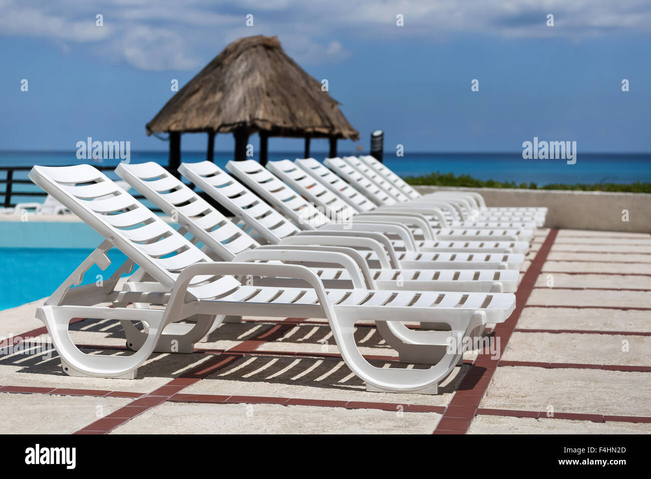 Lounge sunbeds near swimming pool, outdoor near caribbean sea Stock ...