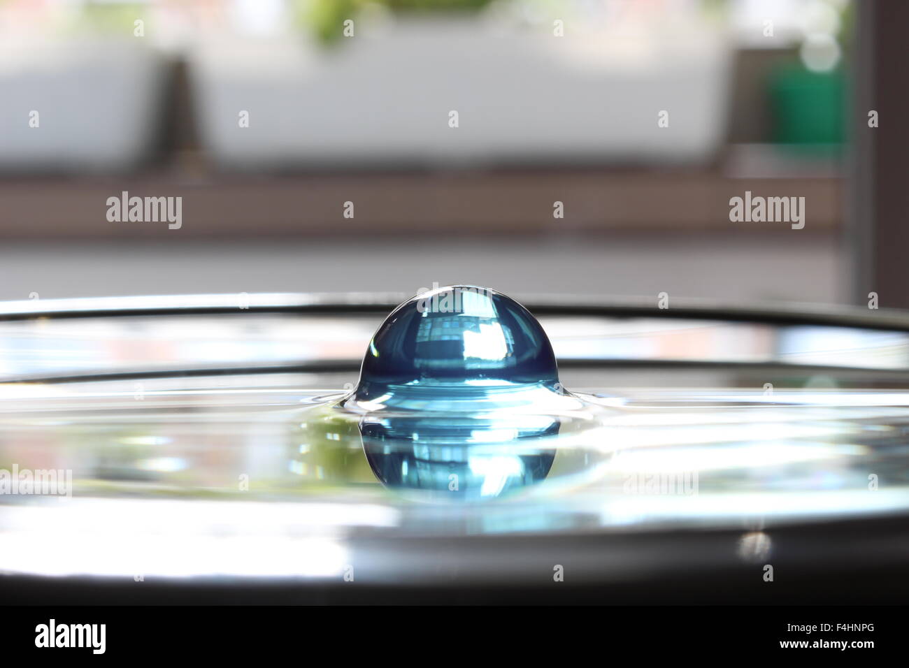 Blue fluid emerging Stock Photo - Alamy