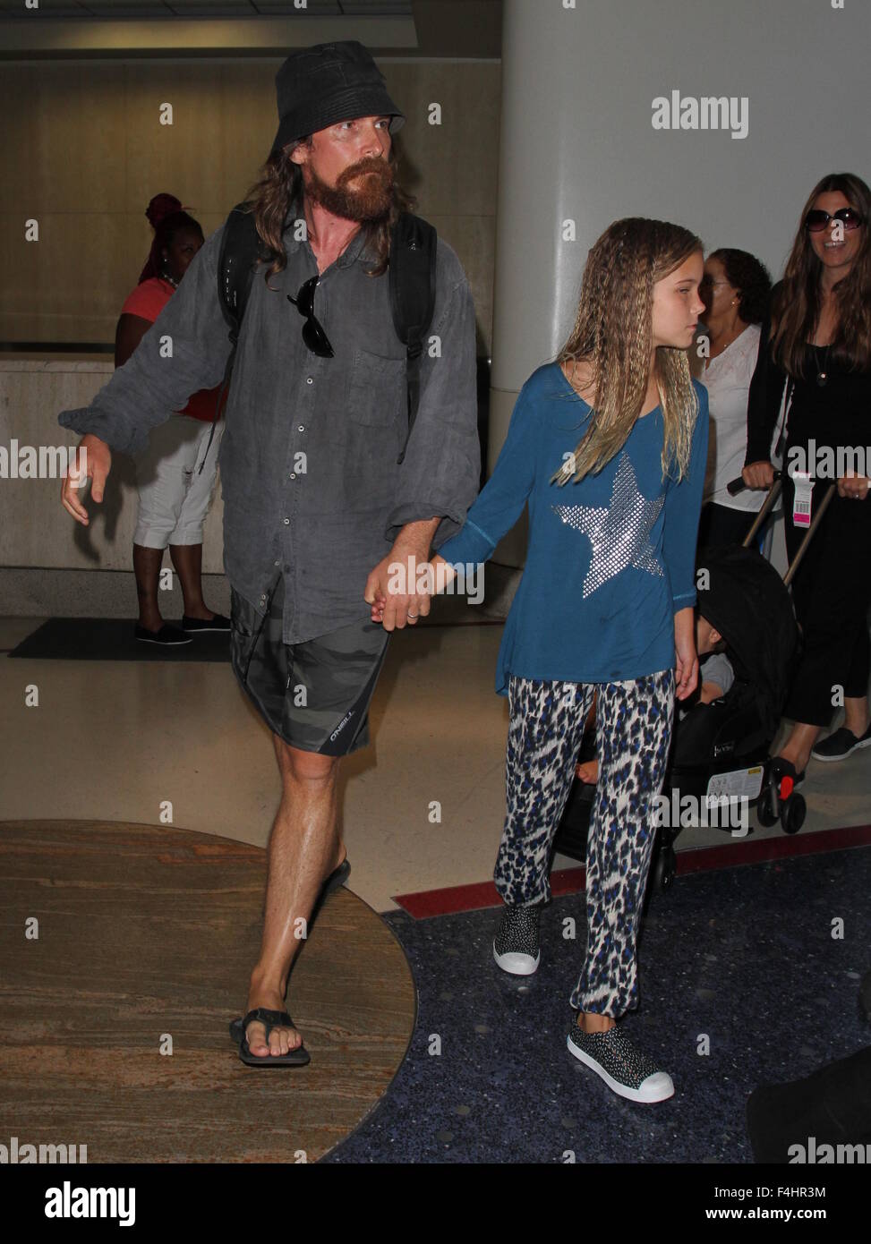 A scruffy Christian Bale arrives at Los Angeles International Airport ...