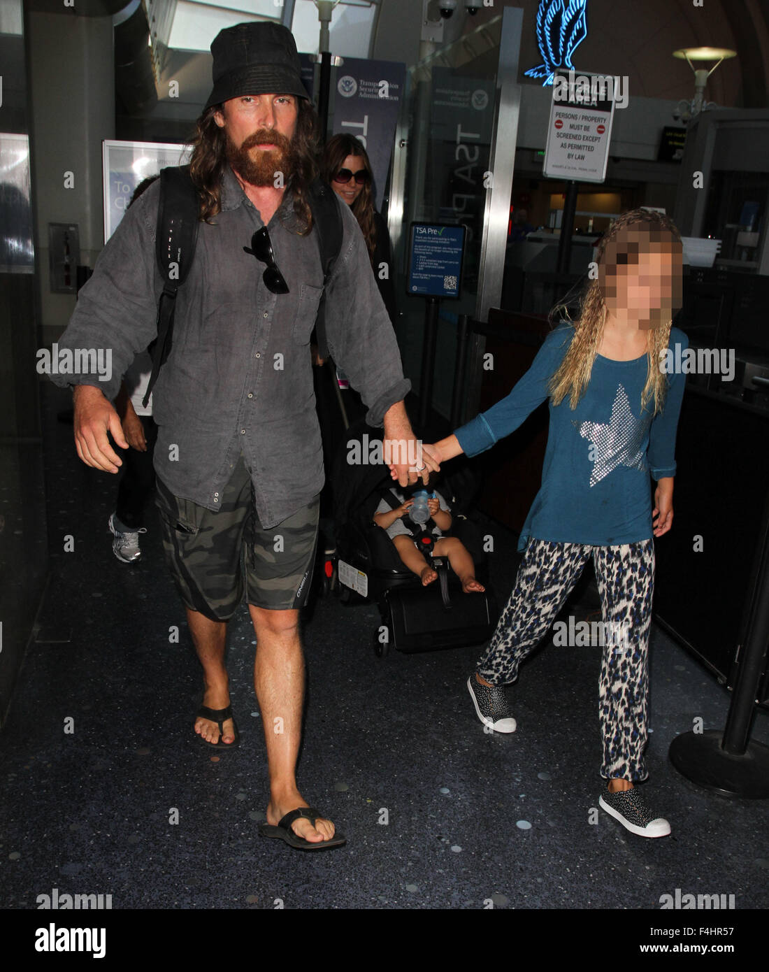 A scruffy Christian Bale arrives at Los Angeles International Airport ...