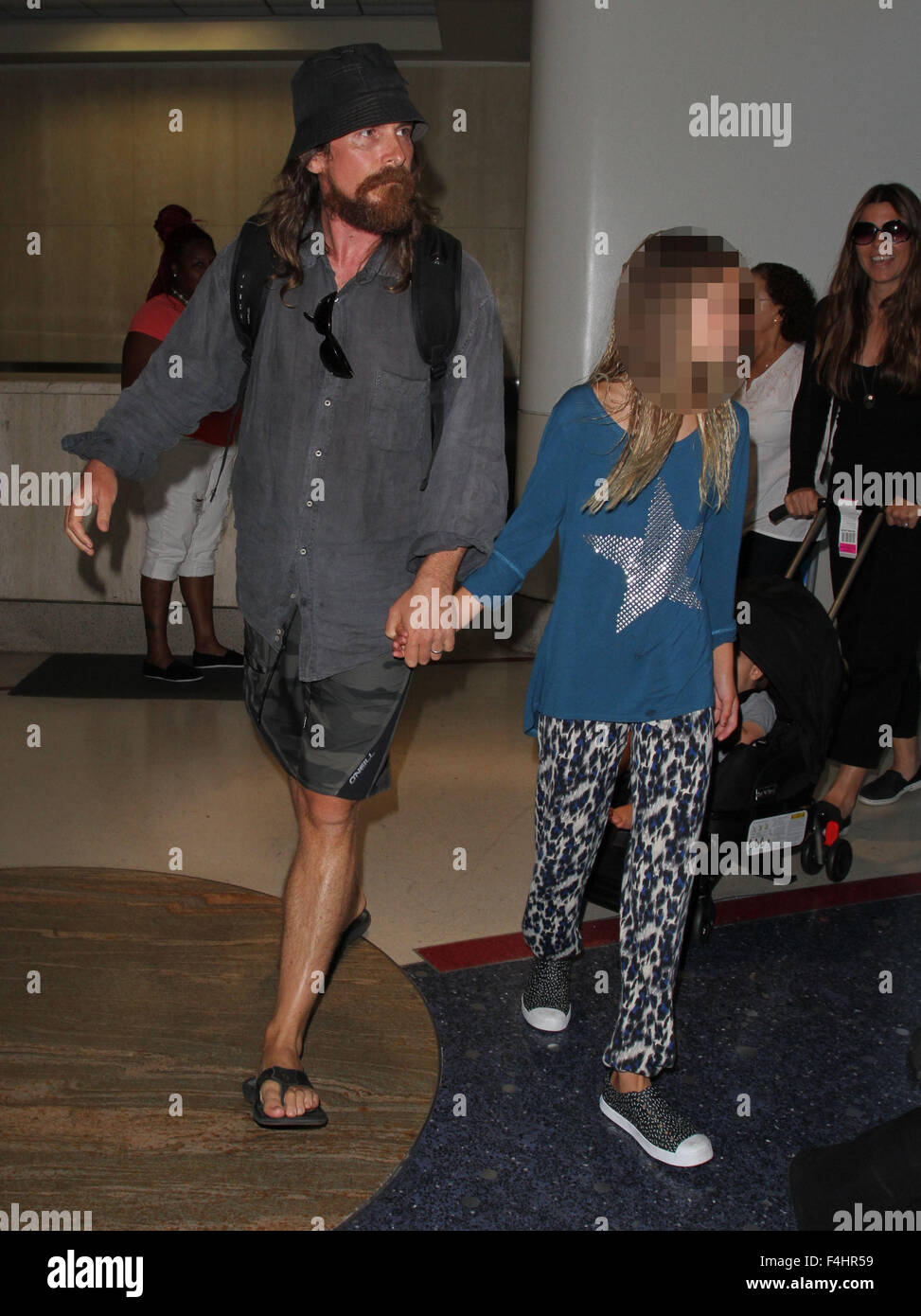 A scruffy Christian Bale arrives at Los Angeles International Airport ...