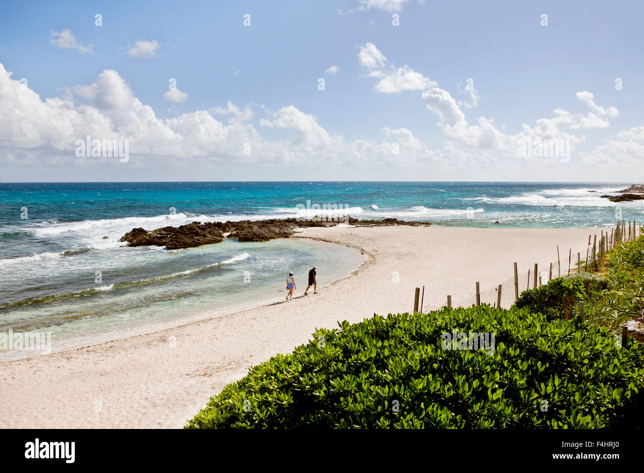A couple walks along Half Moon Beach on the Northem tip of Isla Mujeres ...
