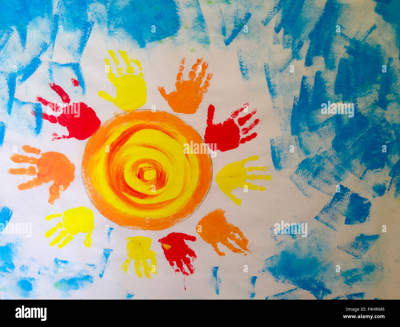 Nursery draw of a sun and sky made with hands prints Stock Photo - Alamy