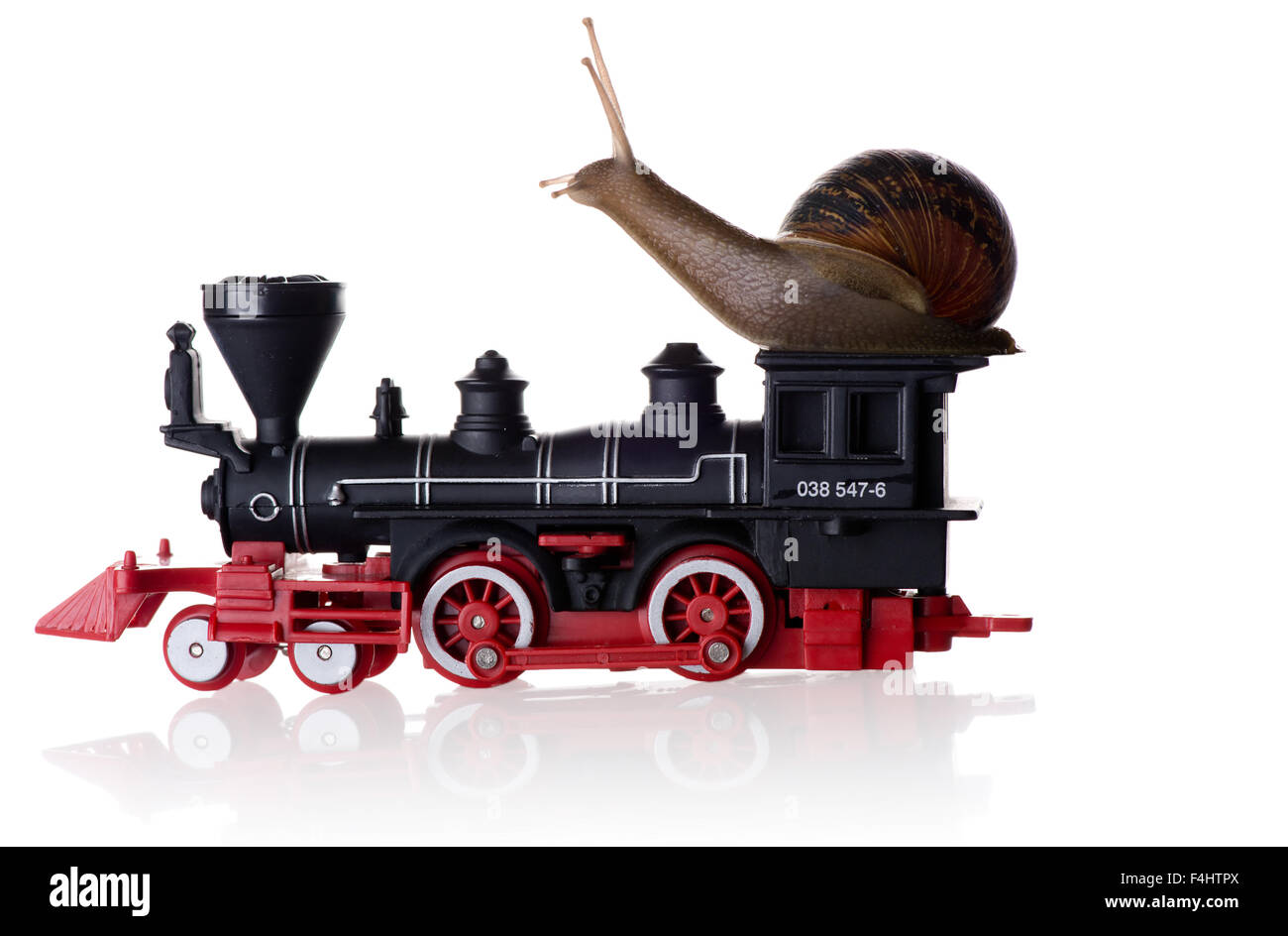 A photo of a snail sitting on a toy train Stock Photo - Alamy
