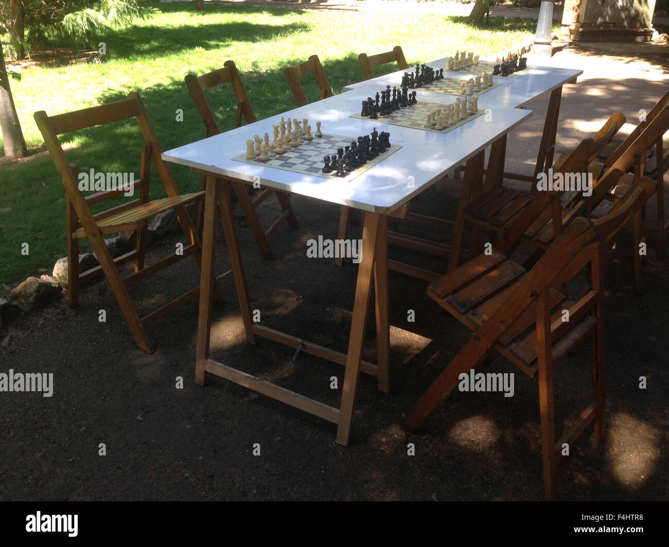 Tables and wooden chairs for chess pieces in the park Stock Photo - Alamy