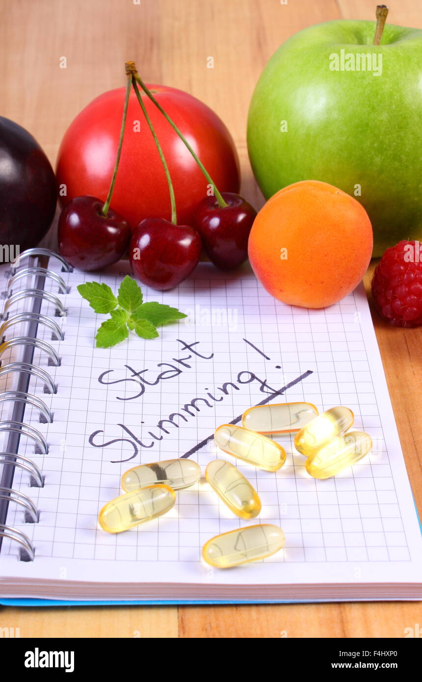 Fresh fruits, vegetables and tablets supplements with notebook for ...
