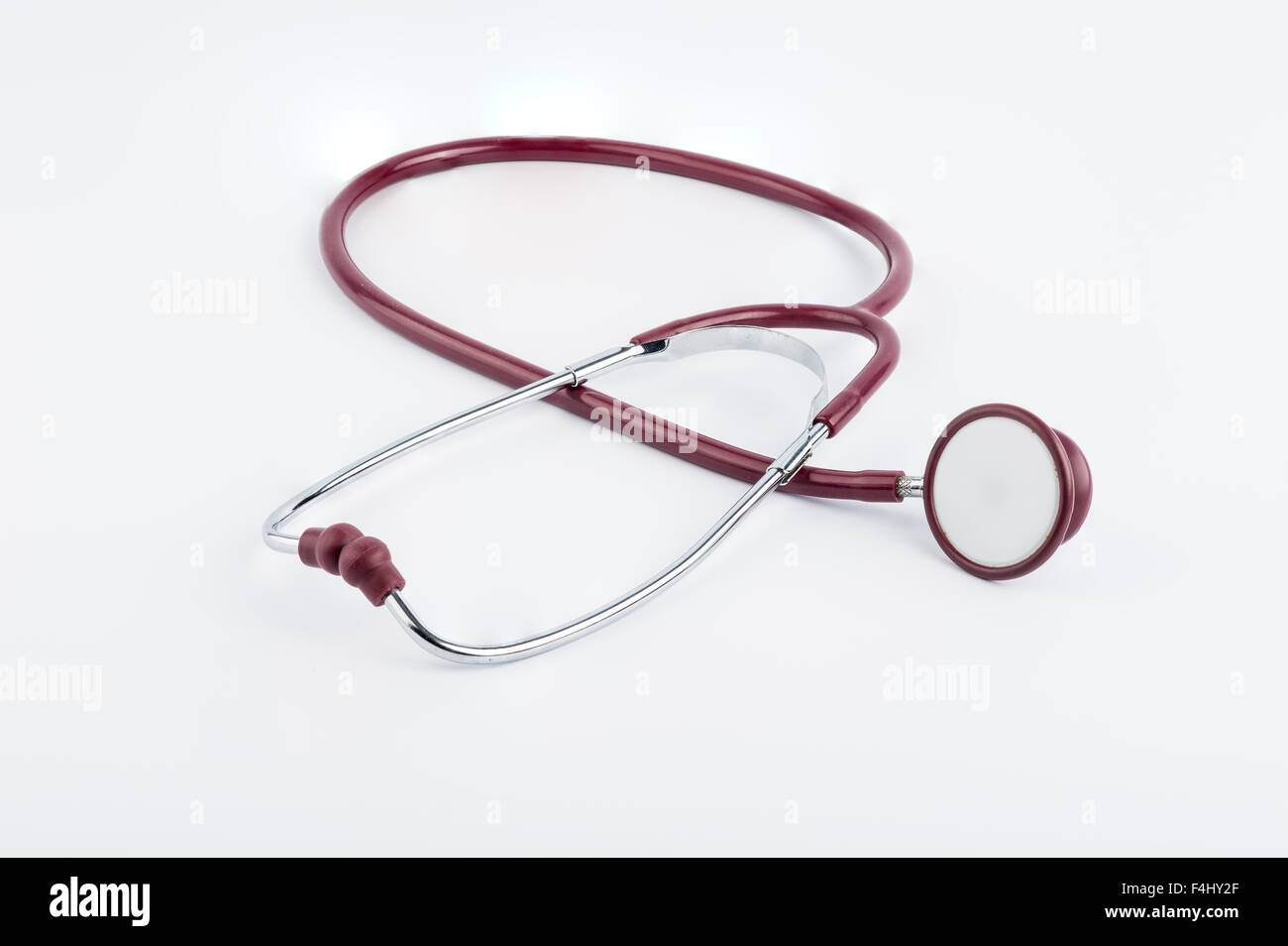 Red stethoscope medical equipment on white background Stock Photo - Alamy
