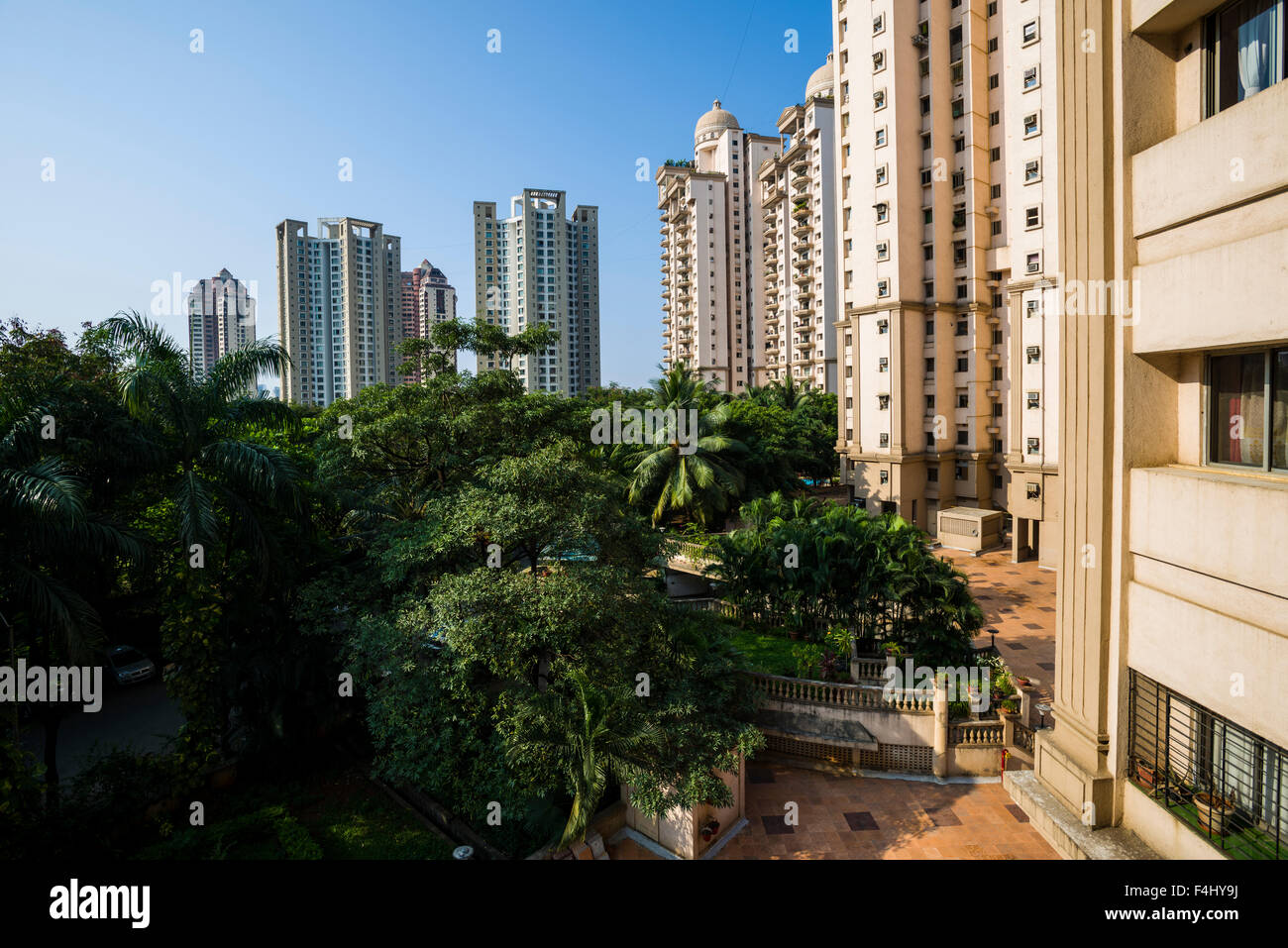 Many high rise buildings set in a compound with palmtrees in a typical ...