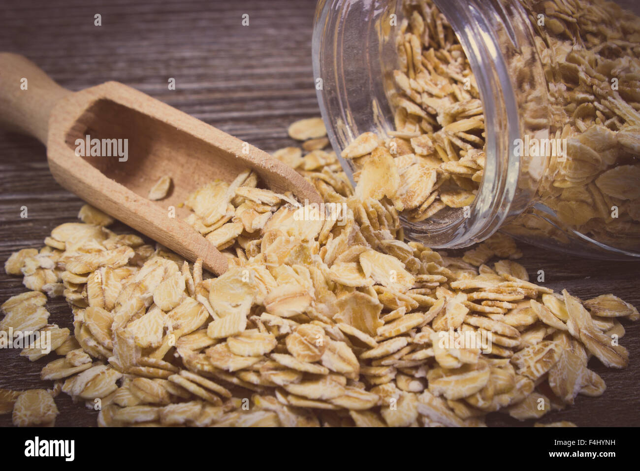 Vintage photo, Heap of organic oatmeal, oat flakes spilling out of ...
