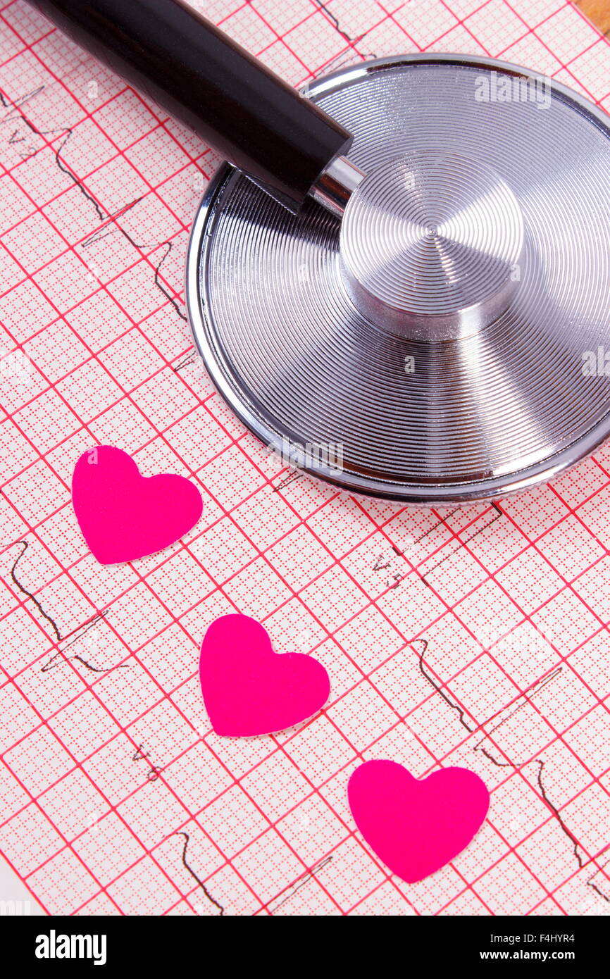 Hearts of paper and medical stethoscope lying on electrocardiogram ...