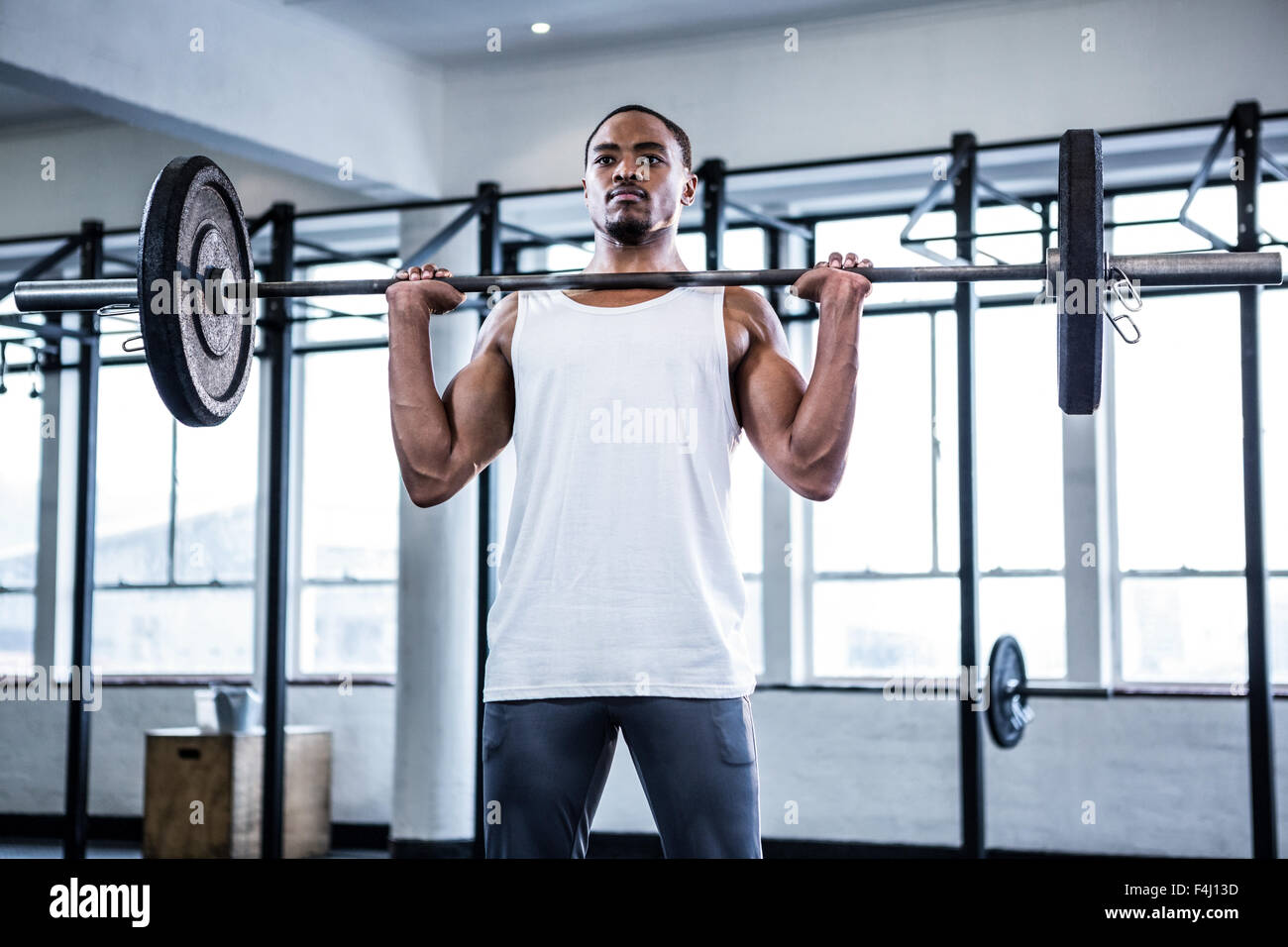 Fit man lifting heavy barbell Stock Photo - Alamy