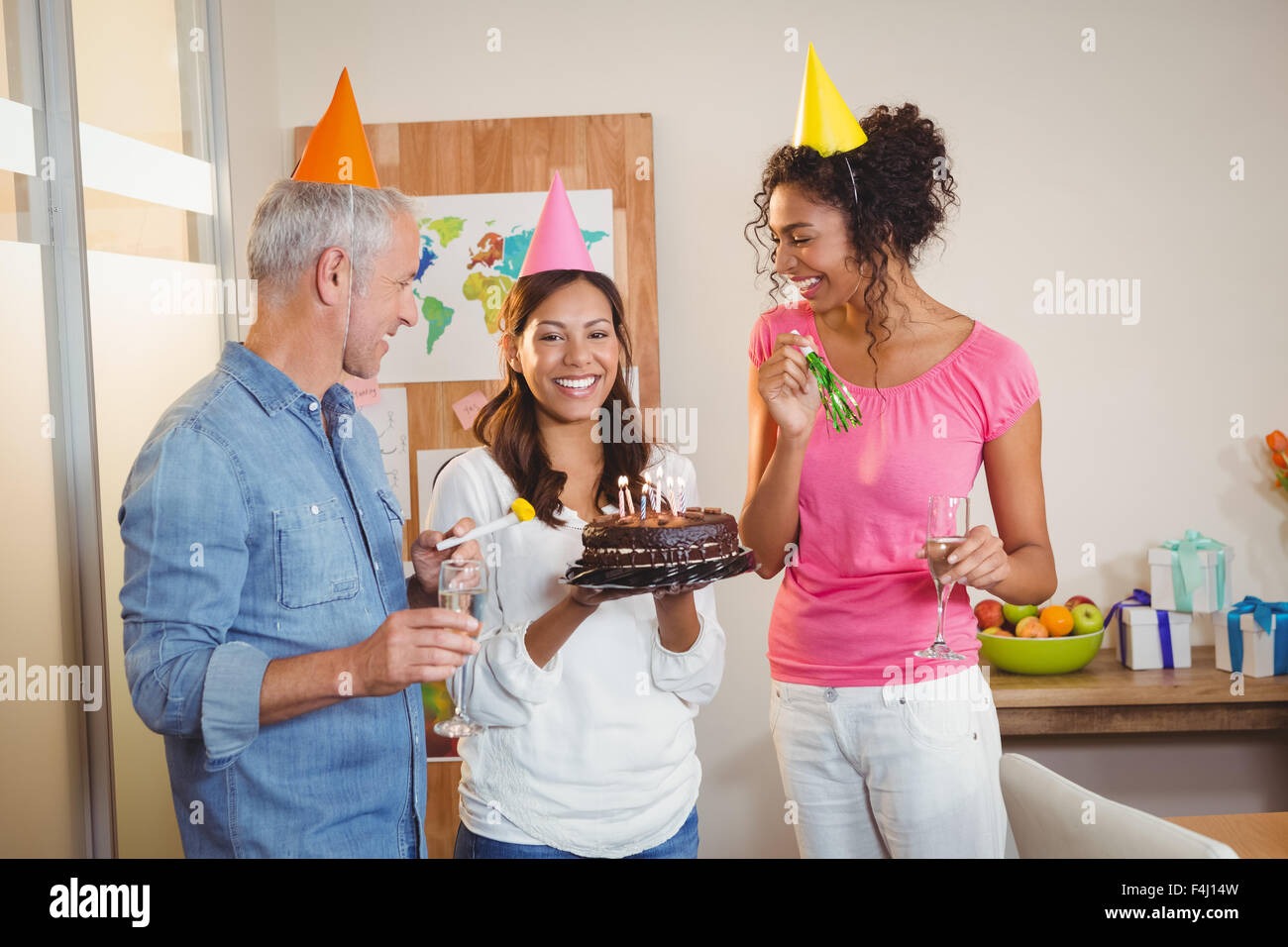Colleagues holding birthday cake hi-res stock photography and images ...