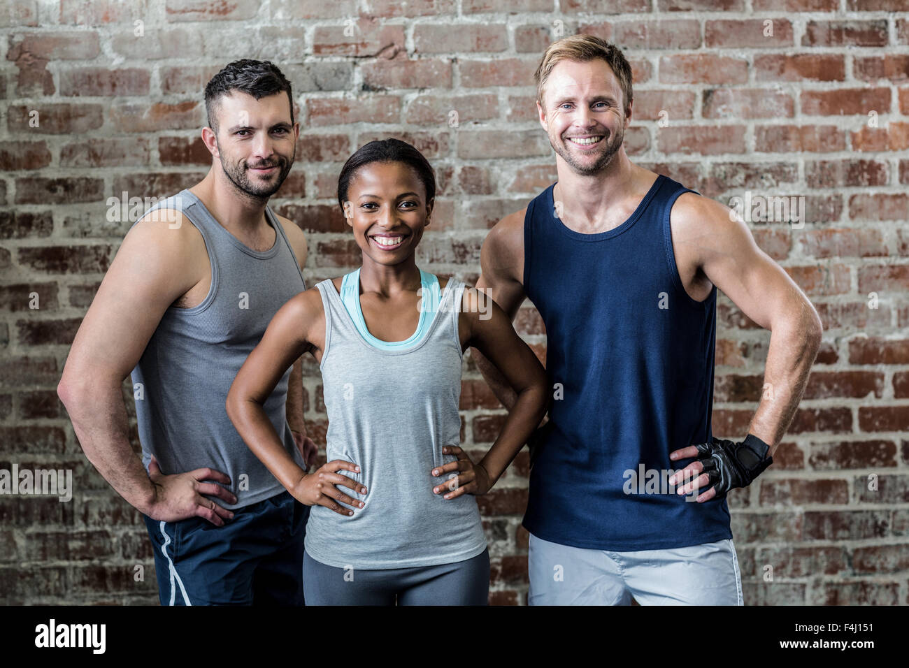 Fit smiling people posing together Stock Photo - Alamy