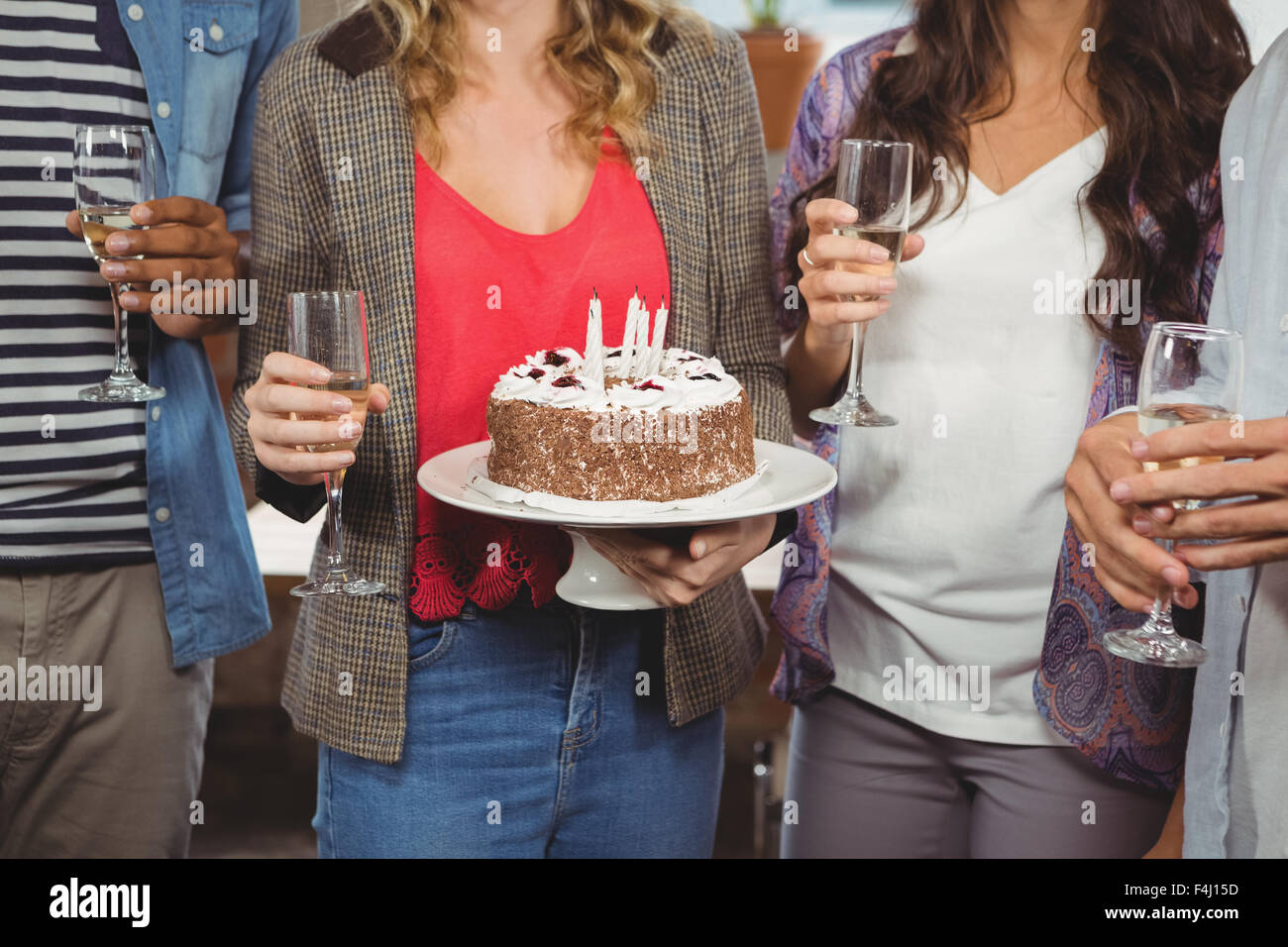 Business people holding birthday cake Stock Photo - Alamy