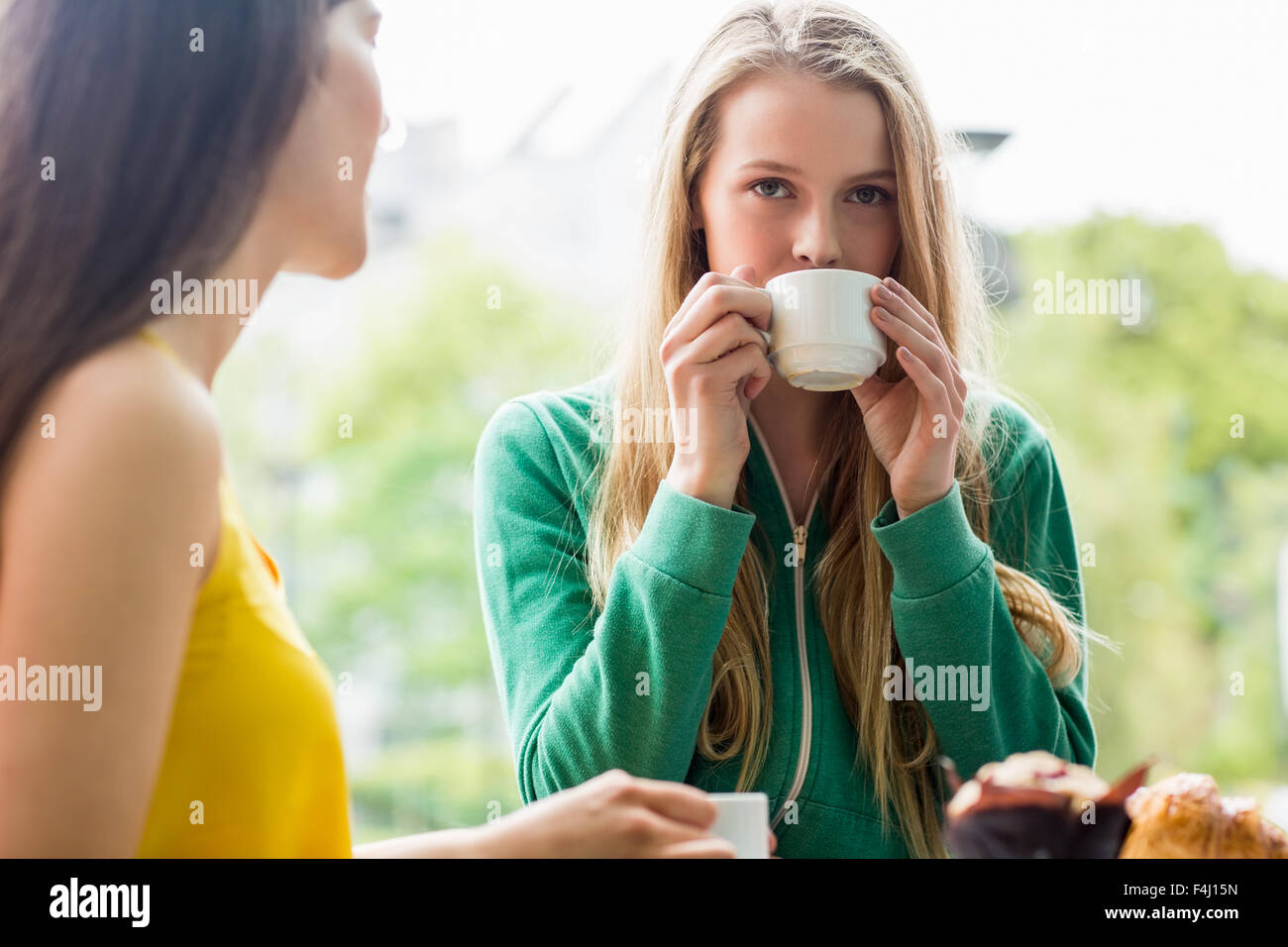 Pretty students having coffee together Stock Photo - Alamy
