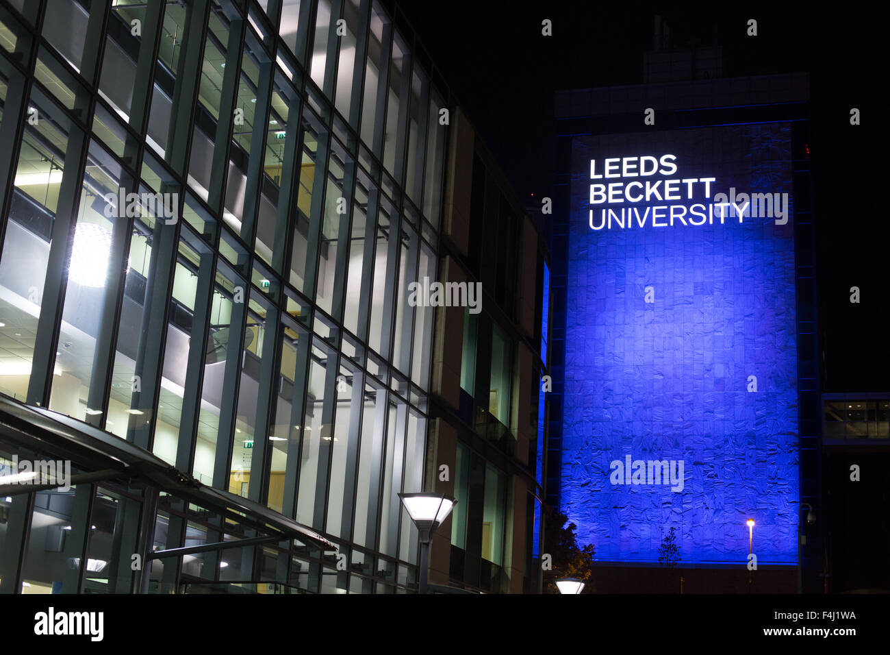 Leeds Beckett University sign lit up at night Stock Photo - Alamy