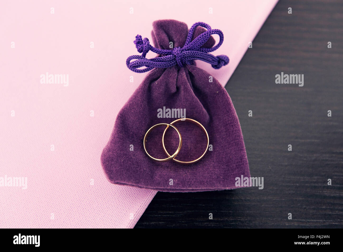 Wedding rings in the purple bag on a table with a purple cloth Stock ...