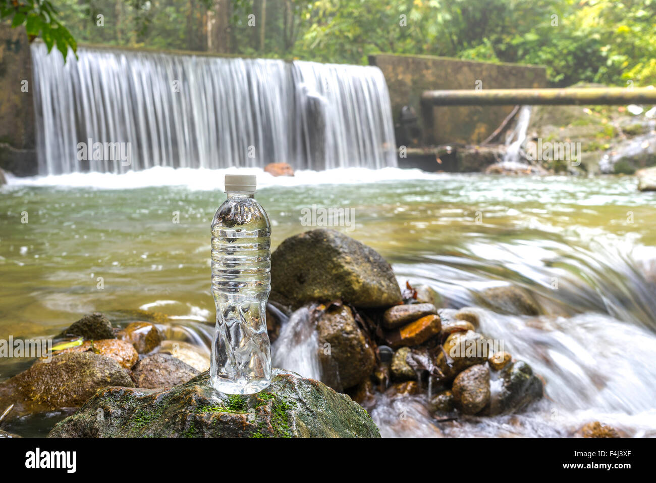 Plastic bottle with waterfall background at tropical forest Stock Photo ...