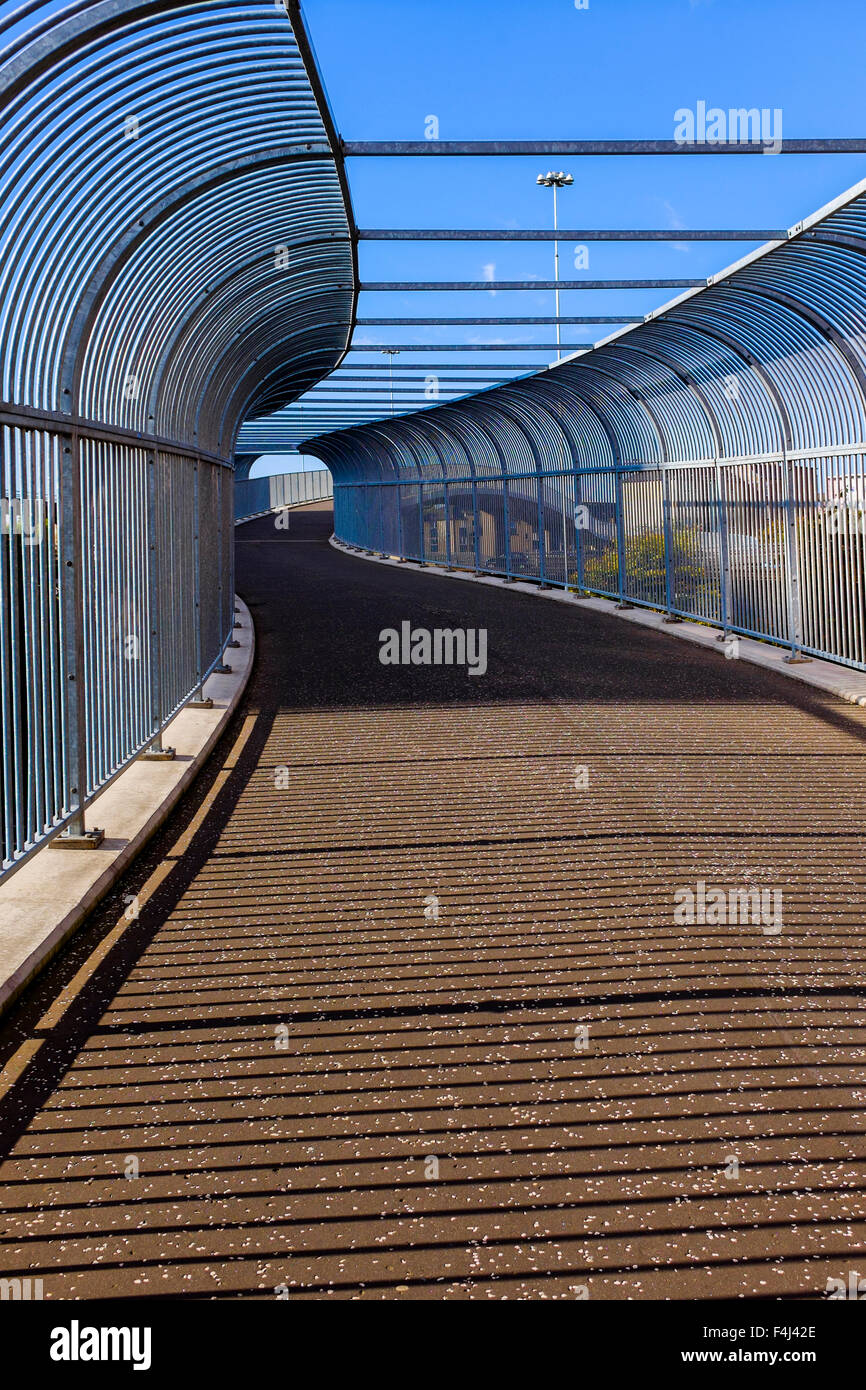 Pedestrian walkway protected by metal rails with shadows, Glasgow ...