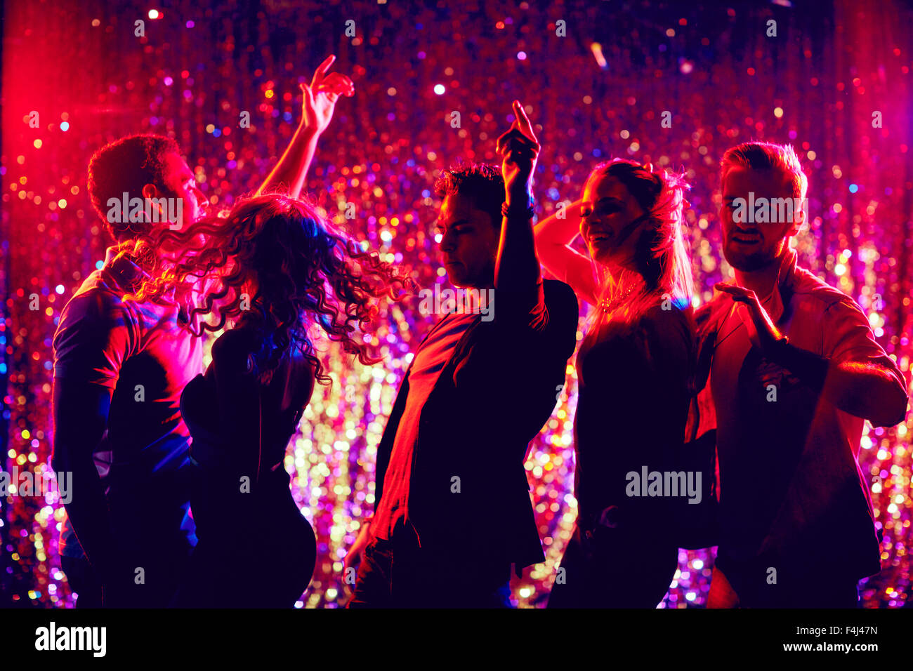 Dynamic young friends dancing at disco party Stock Photo - Alamy
