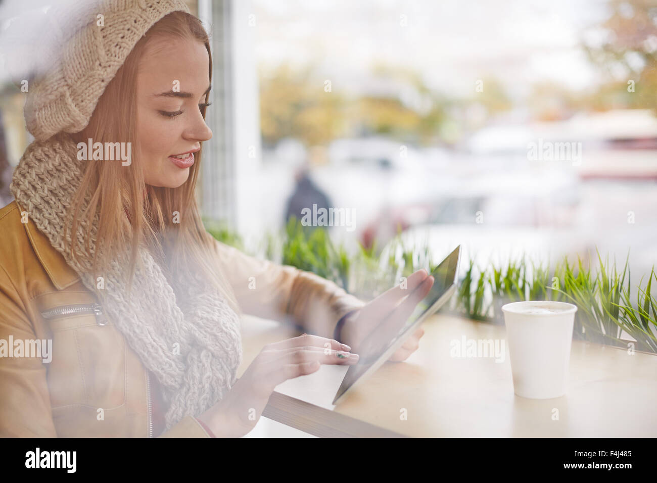 Modern girl with touchpad sitting in cafe Stock Photo - Alamy