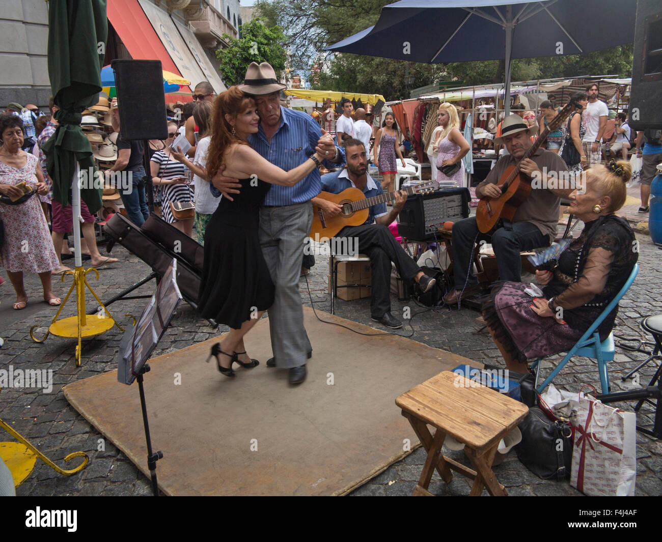 Tango dancers and musicians in the streets of the old barrio of San ...