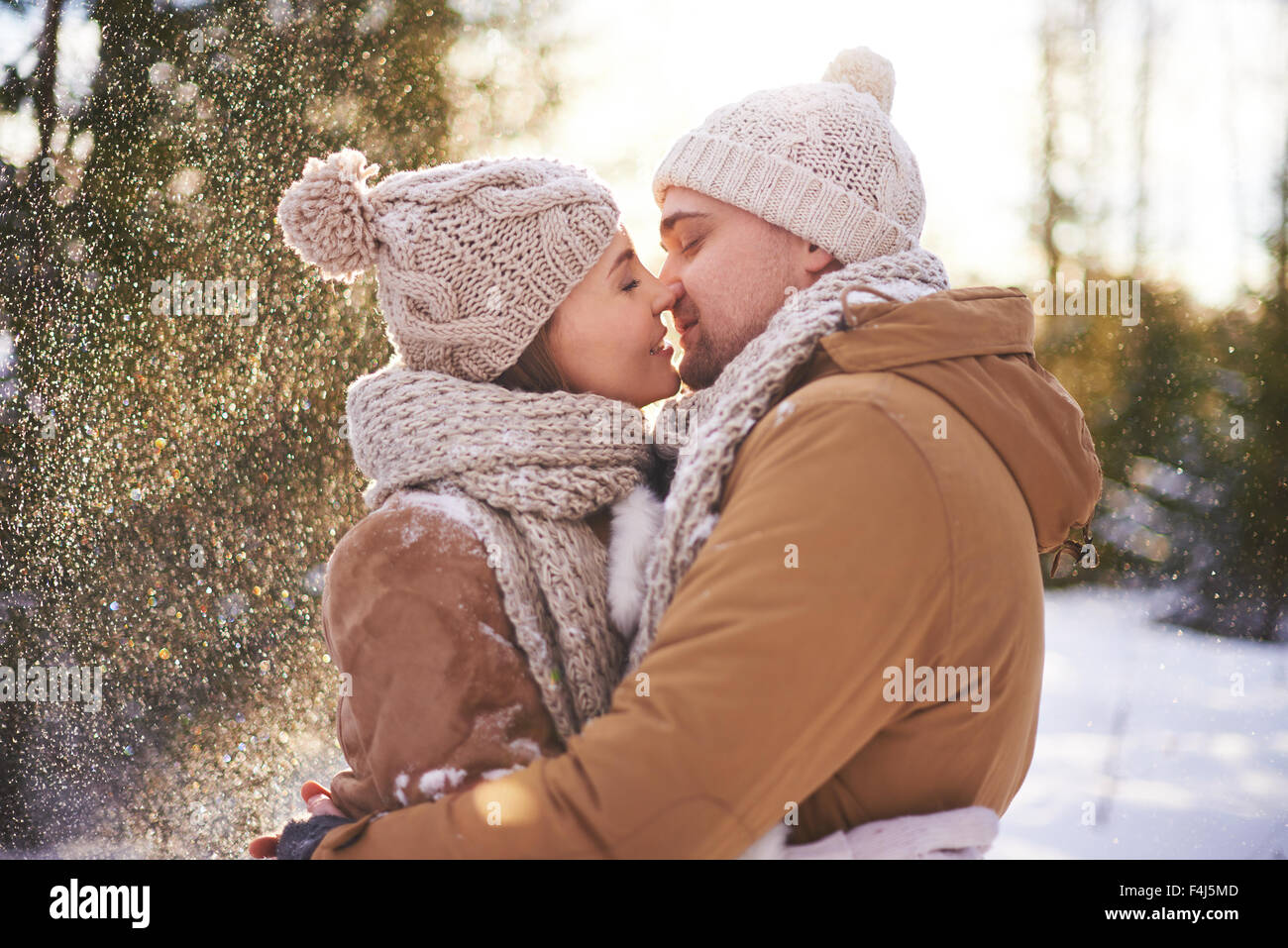 Amorous man and woman kissing on winter day Stock Photo - Alamy