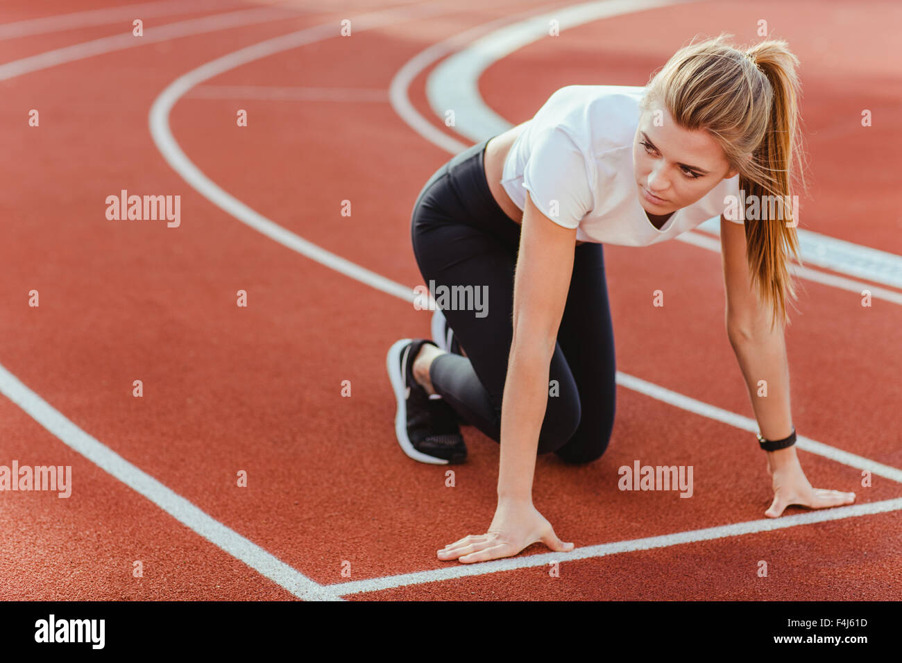 Portrait of a sports woman waiting for the start signal for run Stock ...