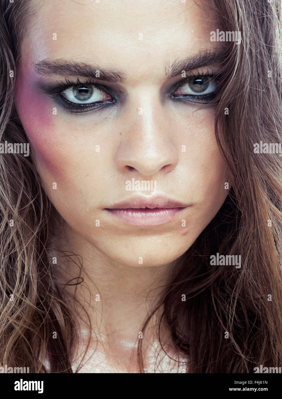 young beauty woman with makeup like shiner on face close up isolated ...