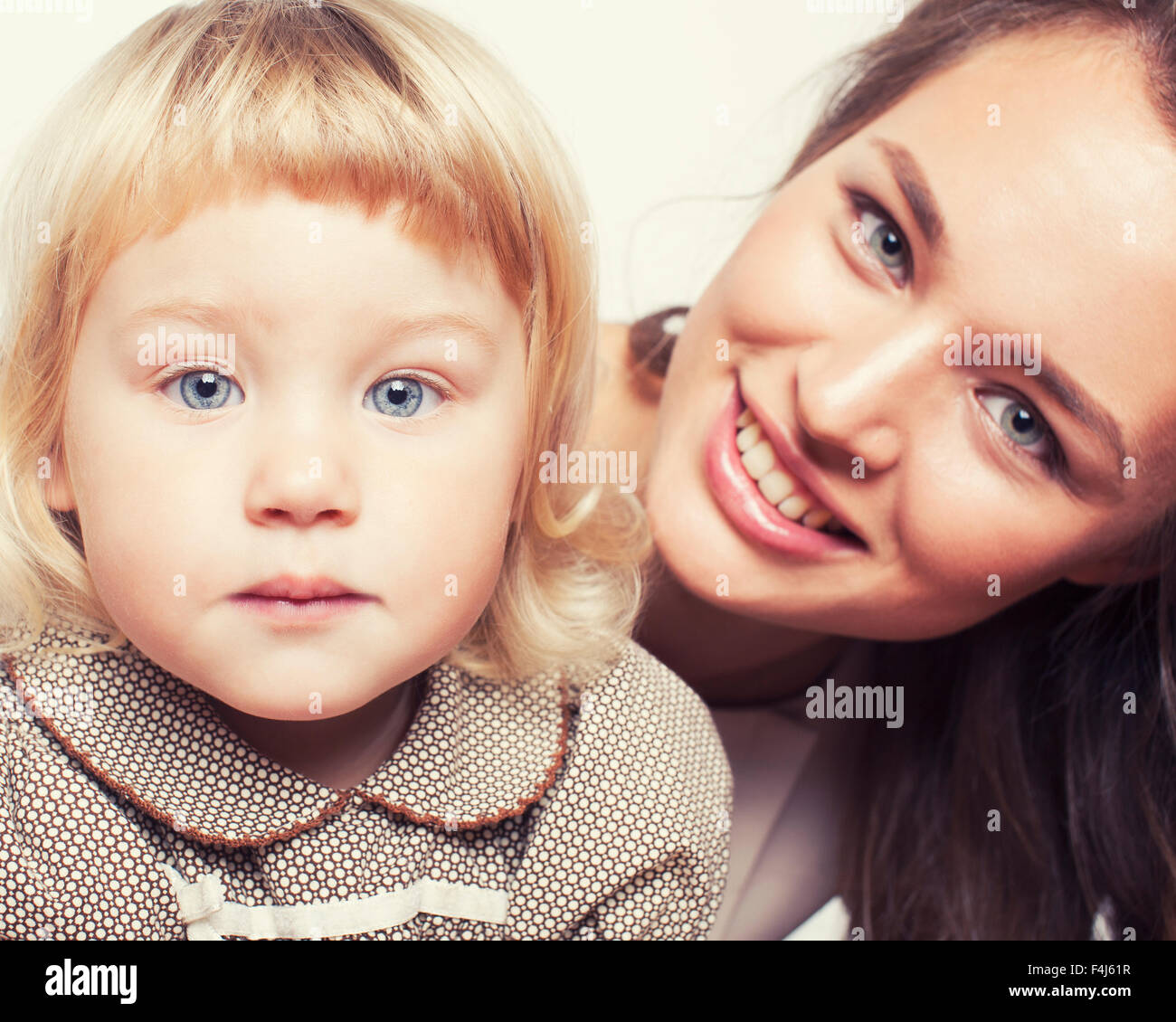 pretty real fashion mother with cute blond little daughter close up ...