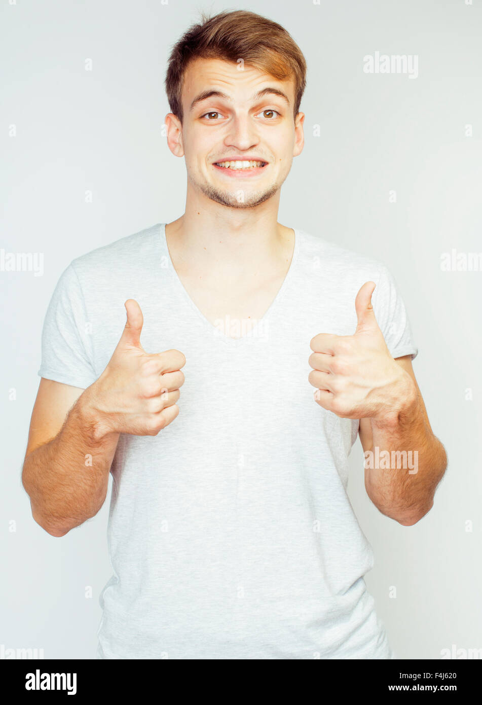 young handsome man on white background gesturing, pointing, posing ...