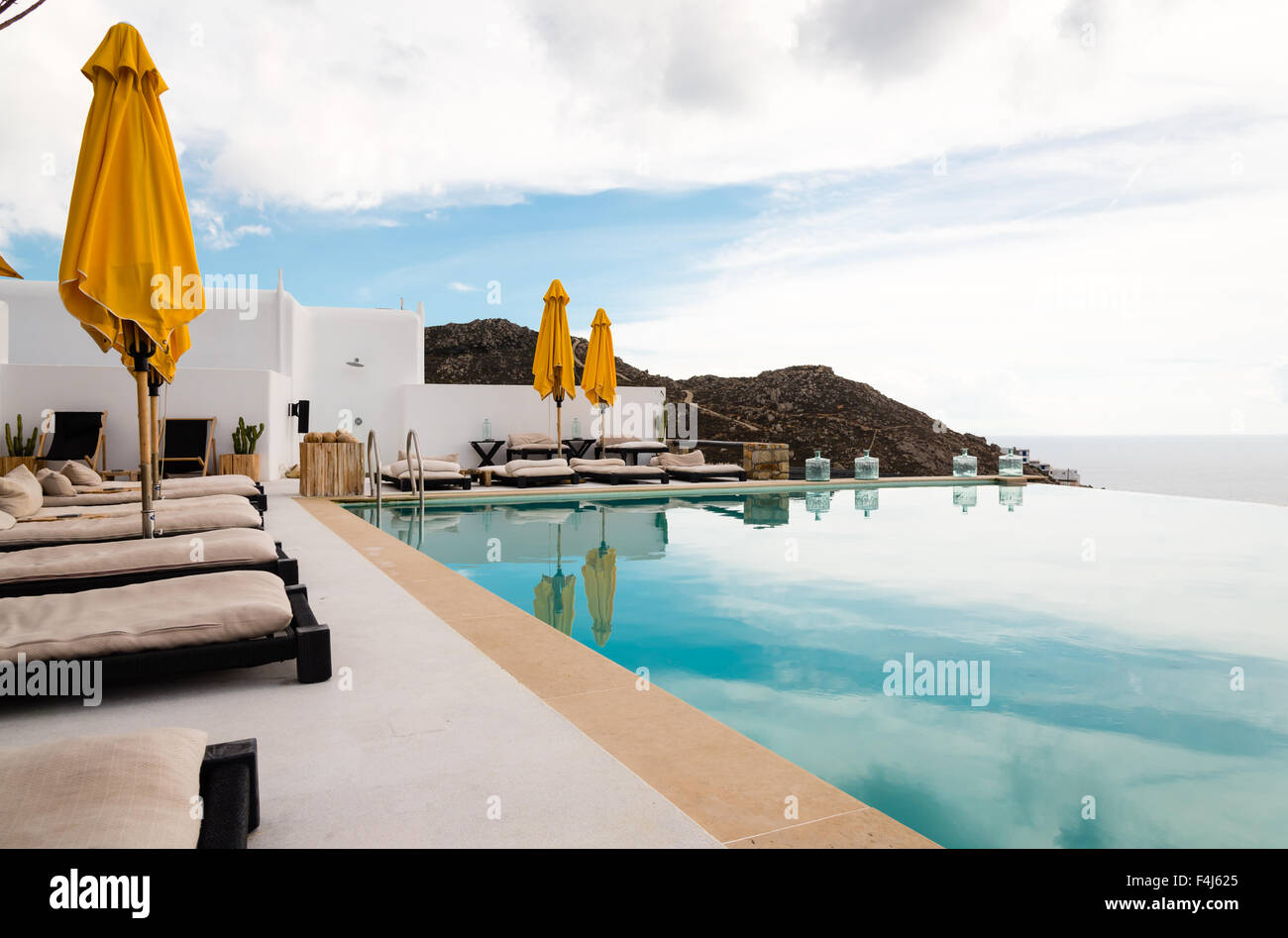 infinity pool at a hotel with yellow umbrellas Stock Photo - Alamy