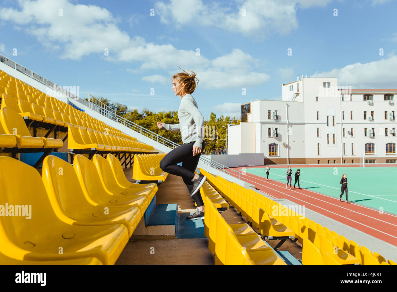 Portrait of a sports woman running at stadium Stock Photo - Alamy
