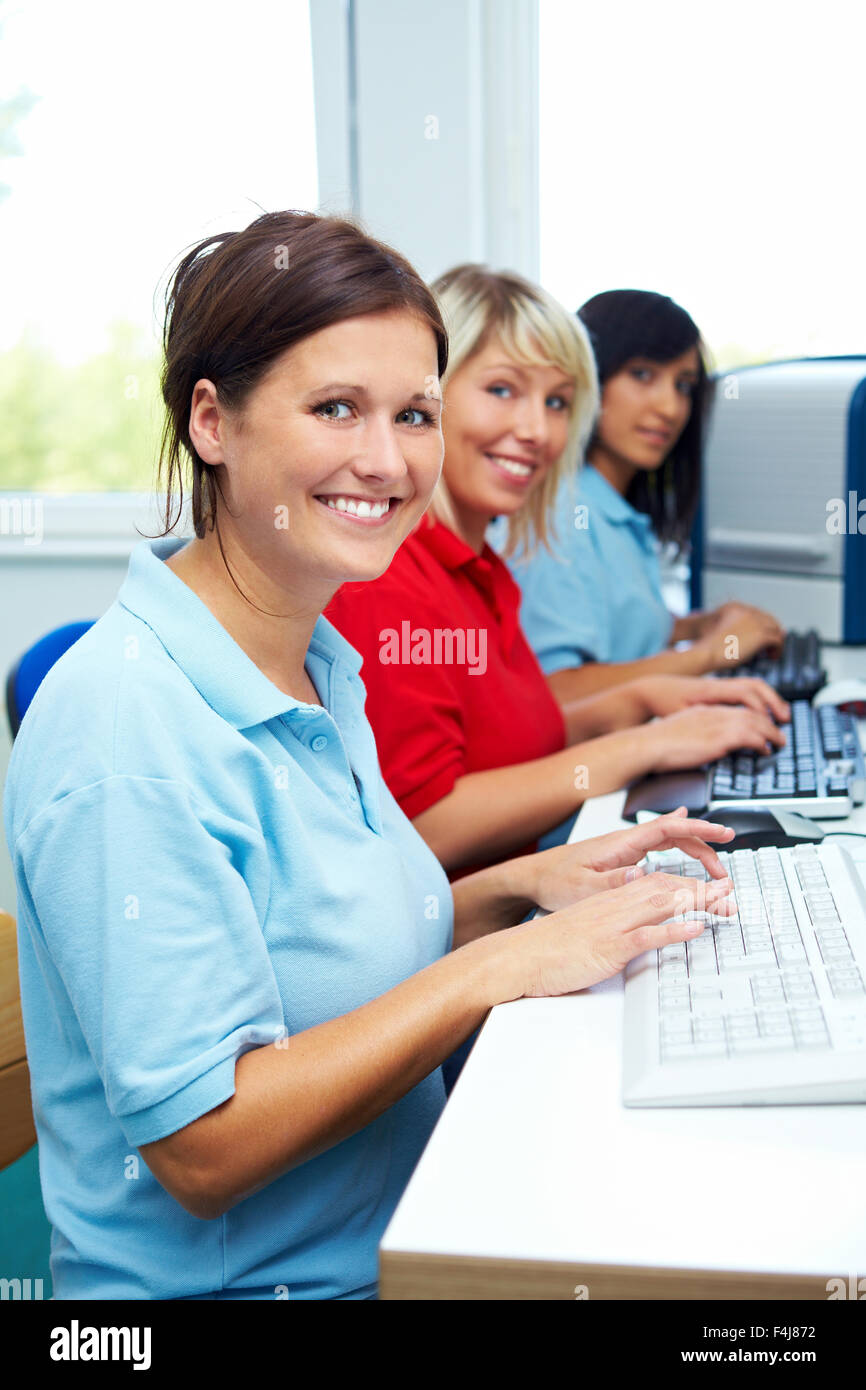 Female workers sitting on computer work stations Stock Photo - Alamy